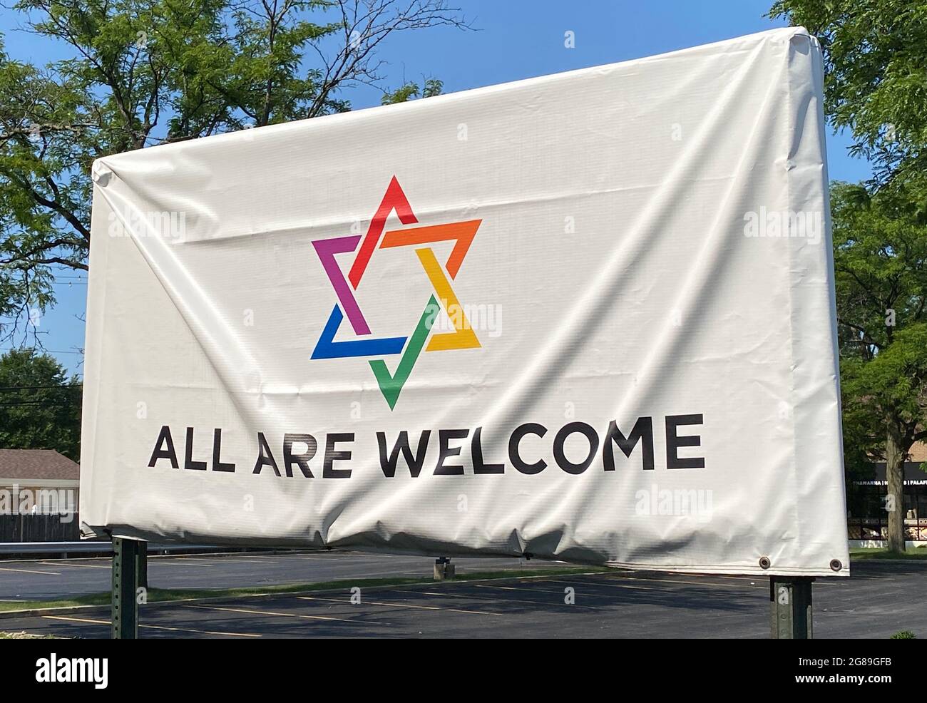 Banner outside a synagogue says "All Are Welcome" with a rainbow Star ...