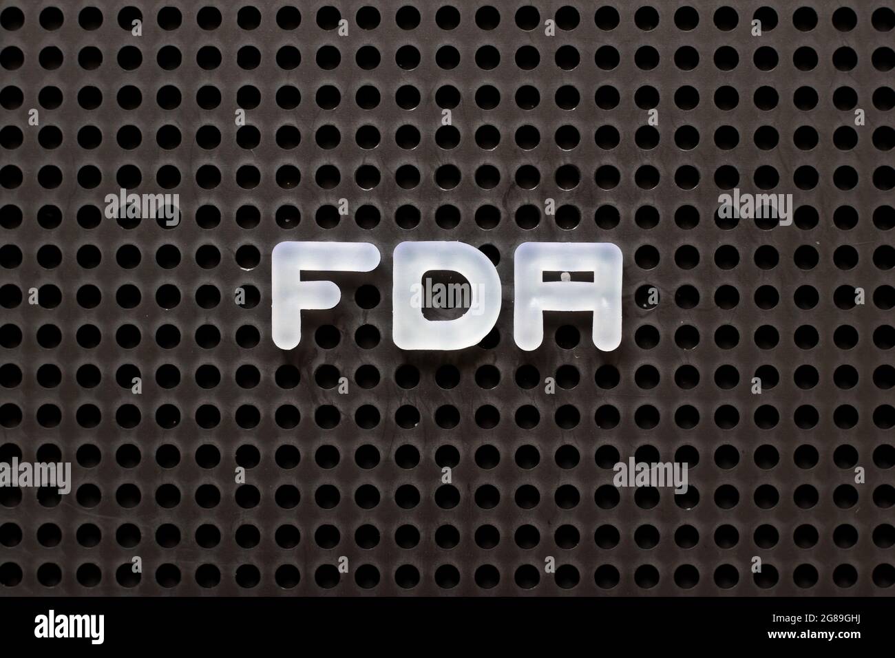 Black color pegboard with white letter in word FDA (abbreviation of ...