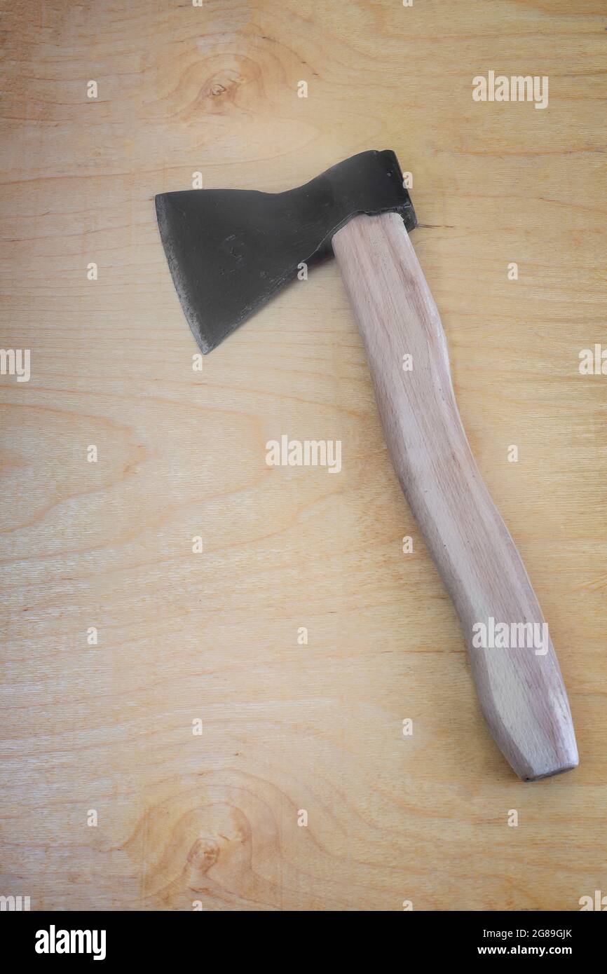 An axe with a wooden axe handle Stock Photo - Alamy