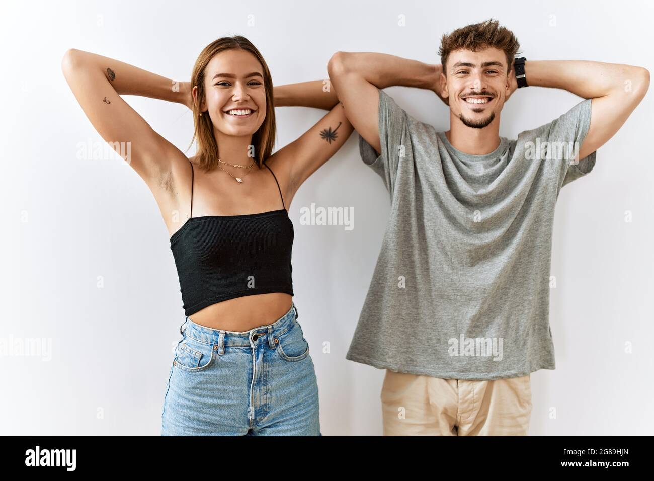 Young beautiful couple standing together over isolated background ...