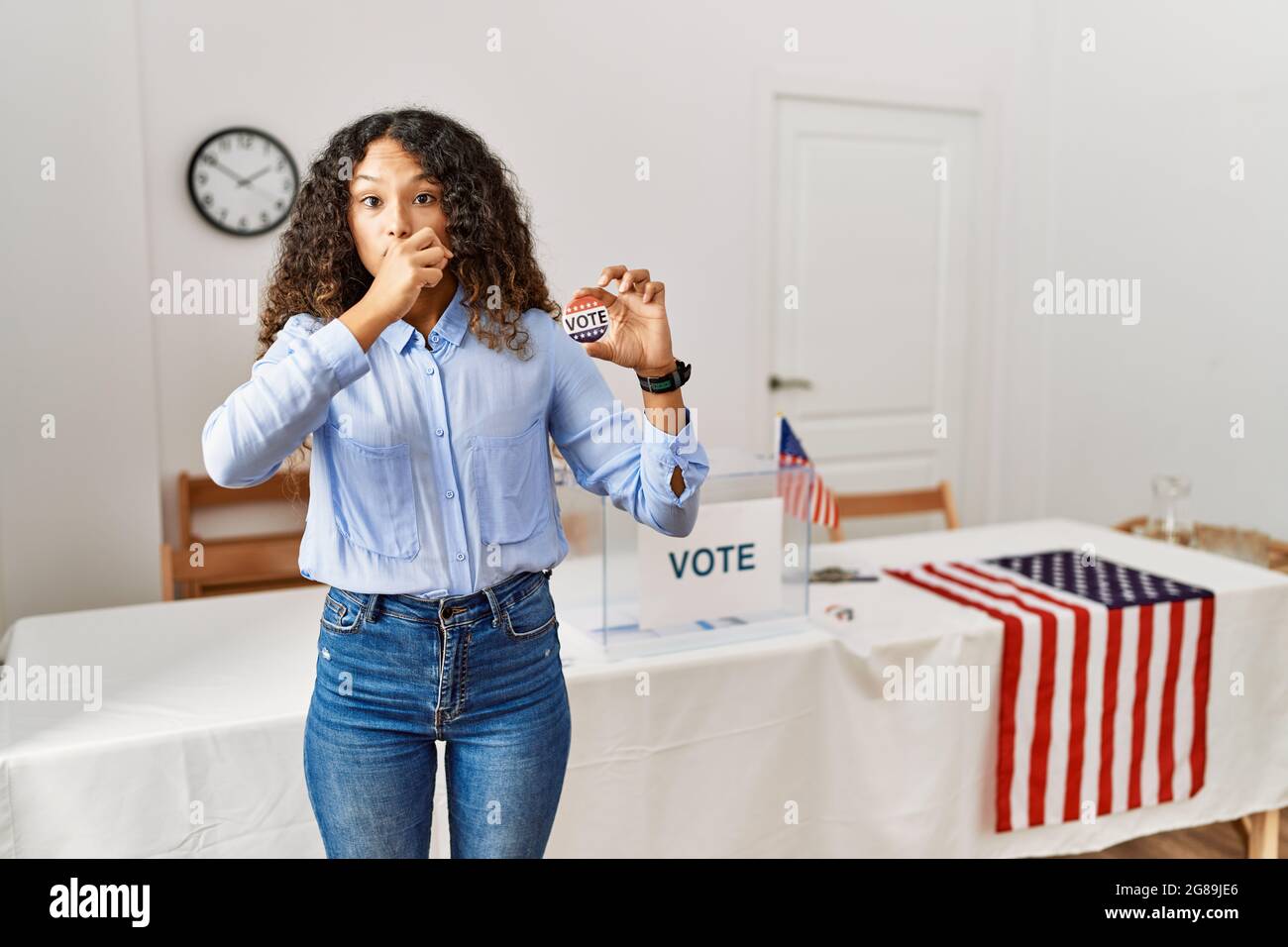 Beautiful hispanic woman standing by at political campaign by voting ...