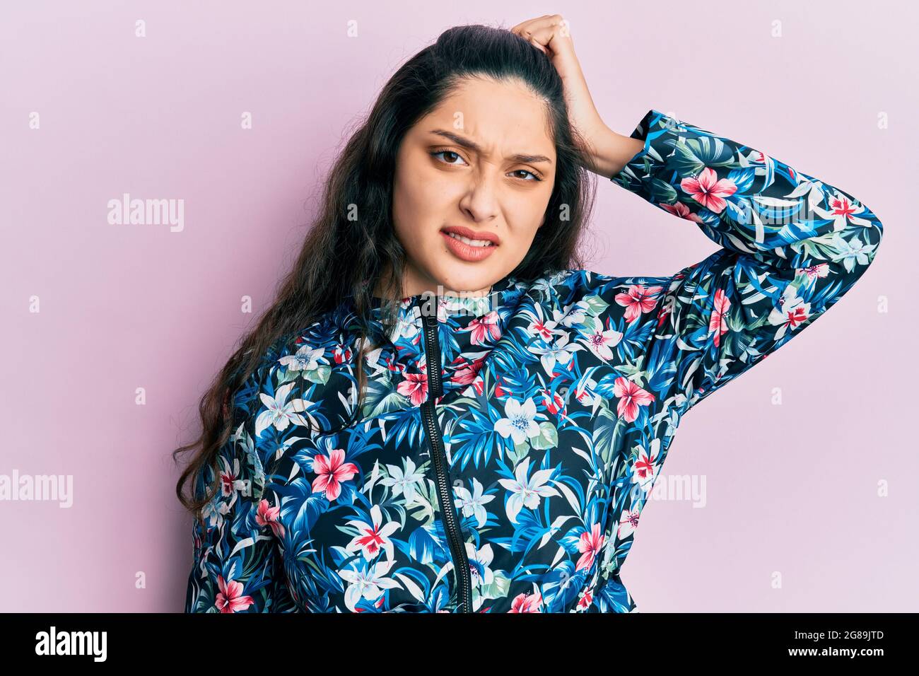 Beautiful middle eastern woman wearing casual floral jacket confuse and ...