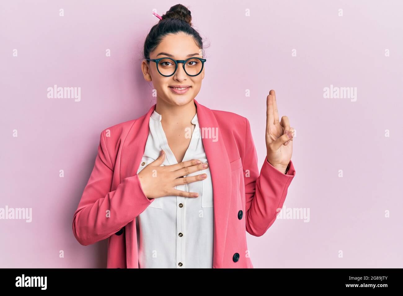 Beautiful middle eastern woman wearing business jacket and glasses ...