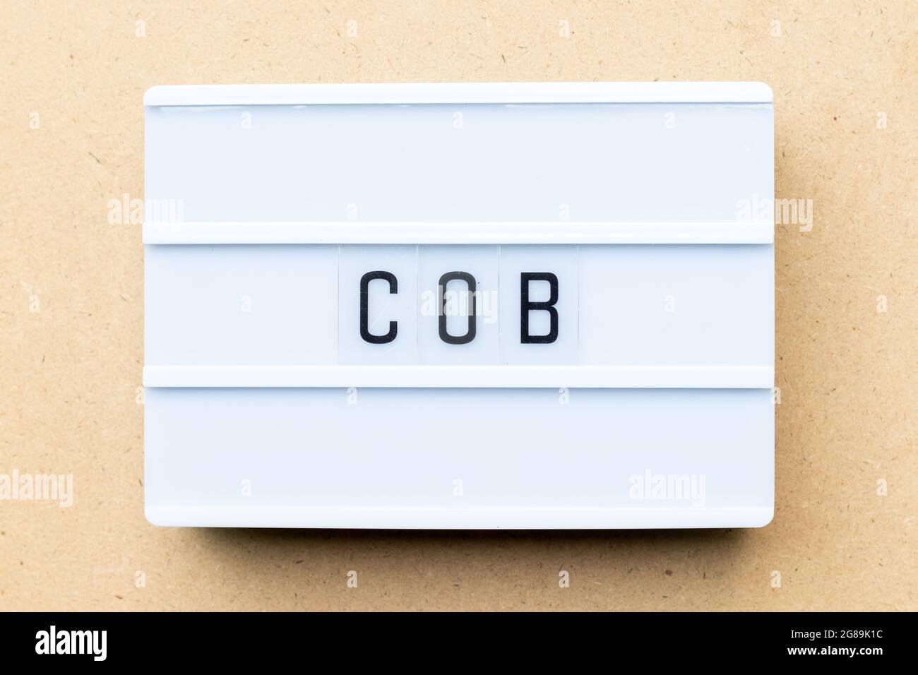 Lightbox with word COB (abbreviation of close of business) on wood ...