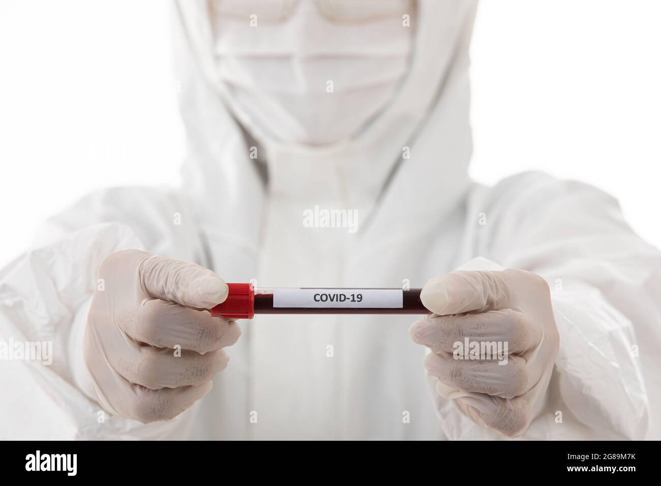 Scientist in sterilizes lab coat cloth holding Covid-19 test tube ...