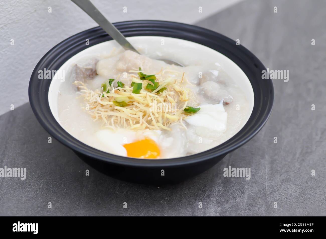 rice gruel, rice porridge or congee with pork liver and egg and ...