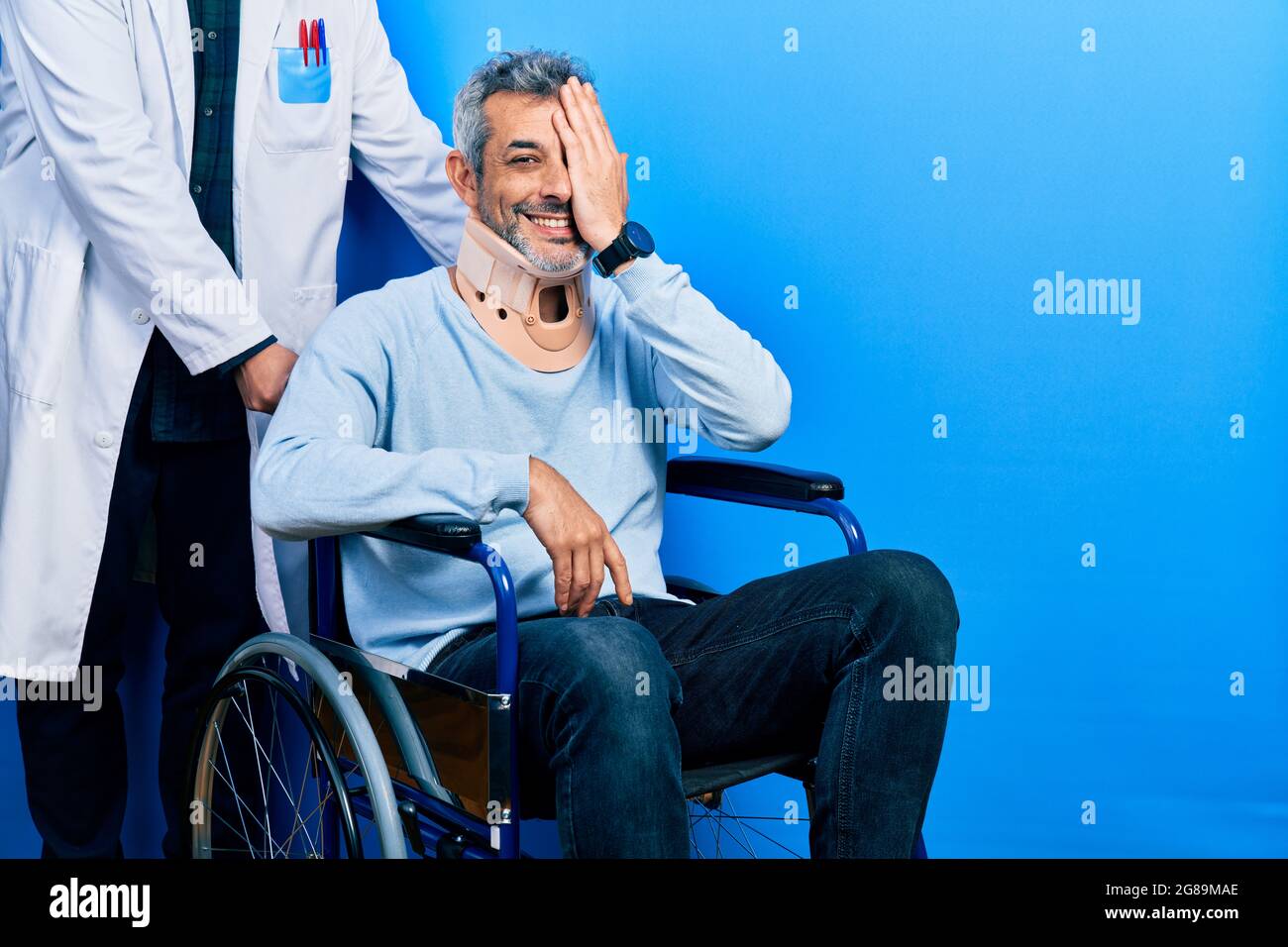 Handsome middle age man with grey hair on wheelchair wearing cervical ...