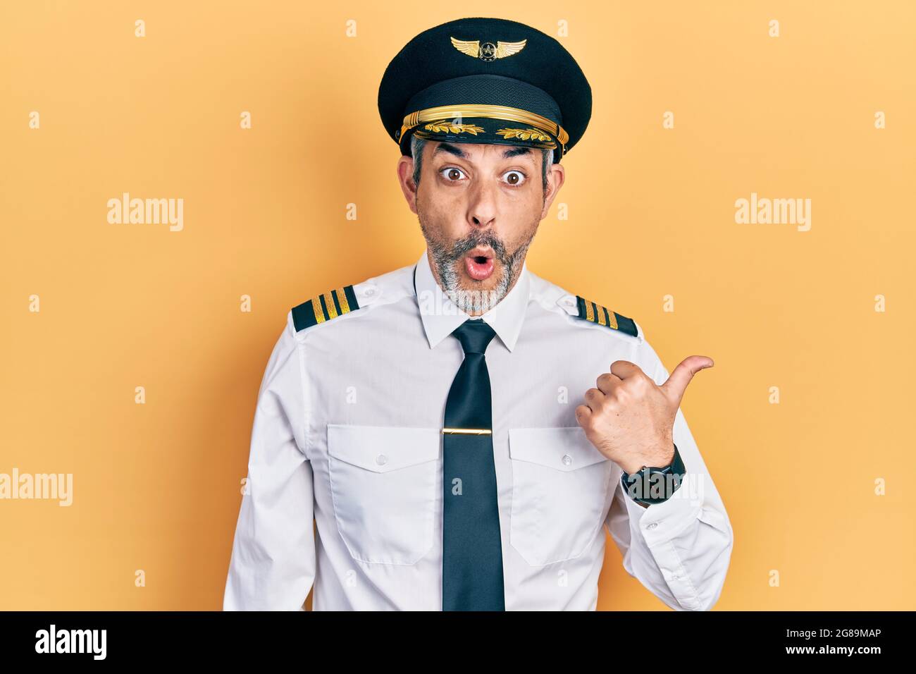 Handsome middle age man with grey hair wearing airplane pilot uniform ...