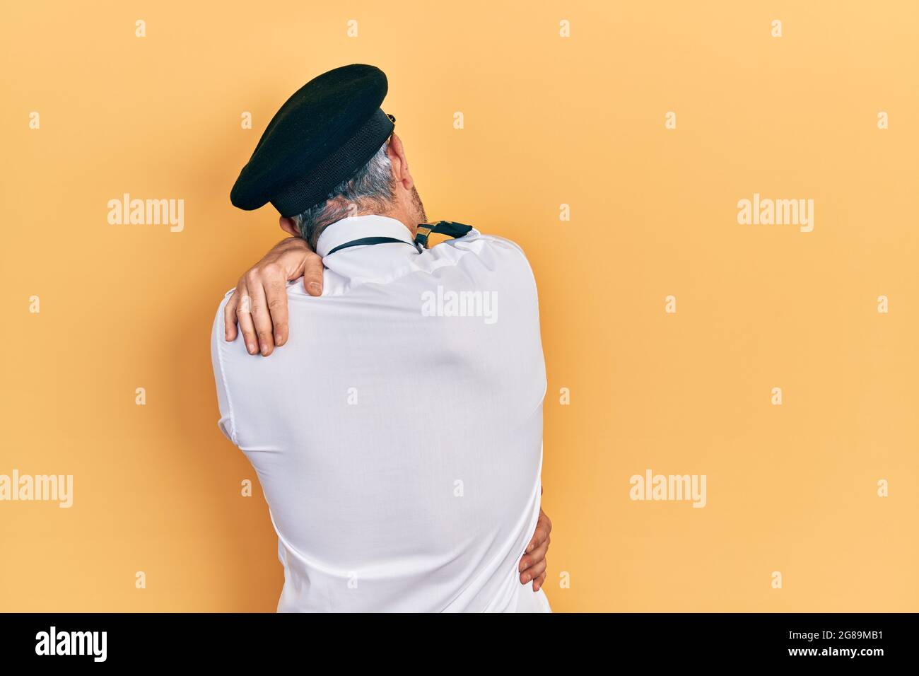 Handsome middle age man with grey hair wearing airplane pilot uniform ...