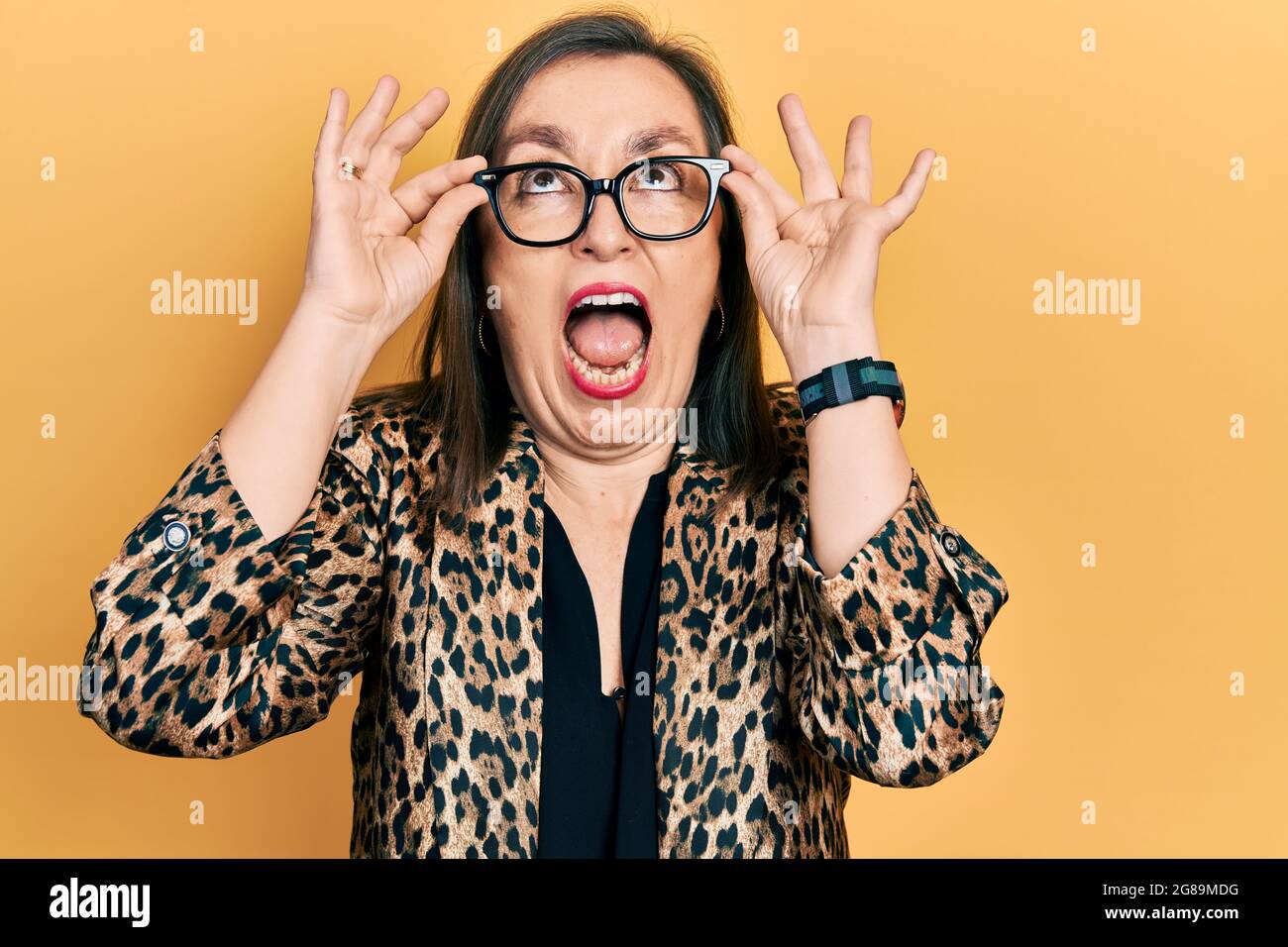 Middle Age Hispanic Woman Wearing Business Clothes And Holding Glasses