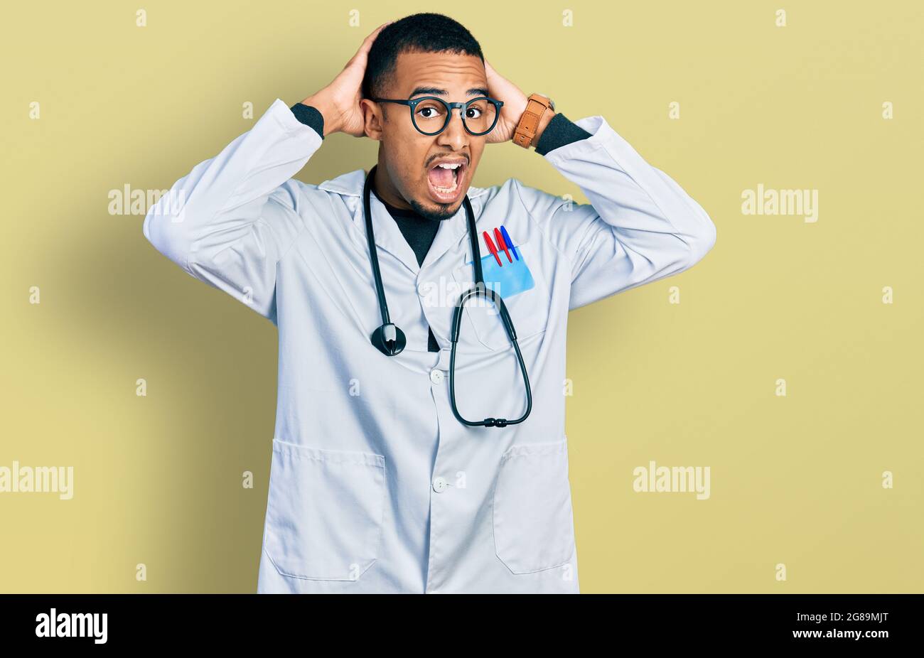Young african american man wearing doctor uniform and stethoscope crazy ...