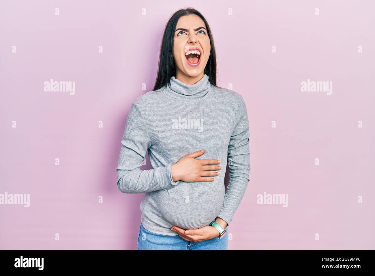 Beautiful woman with blue eyes expecting a baby, touching pregnant ...