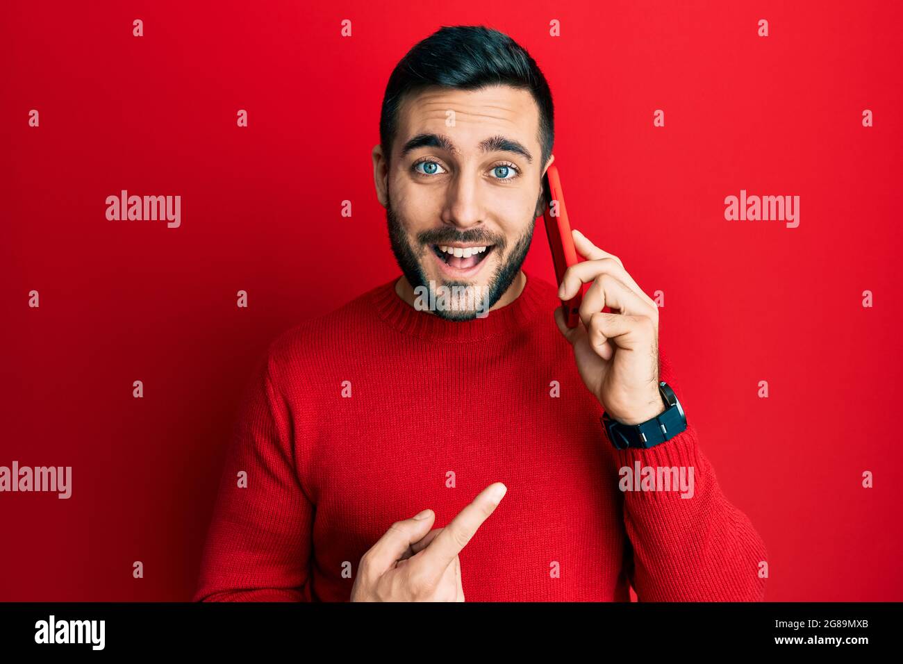 Young hispanic man having conversation talking on the smartphone ...