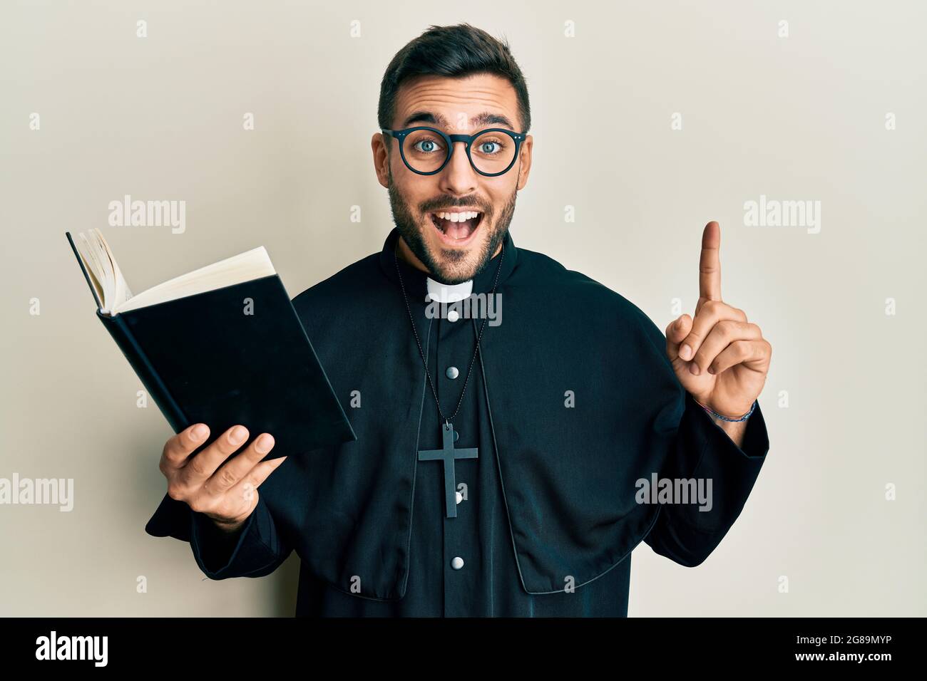 Portrait priest holding bible smiling hi-res stock photography and ...