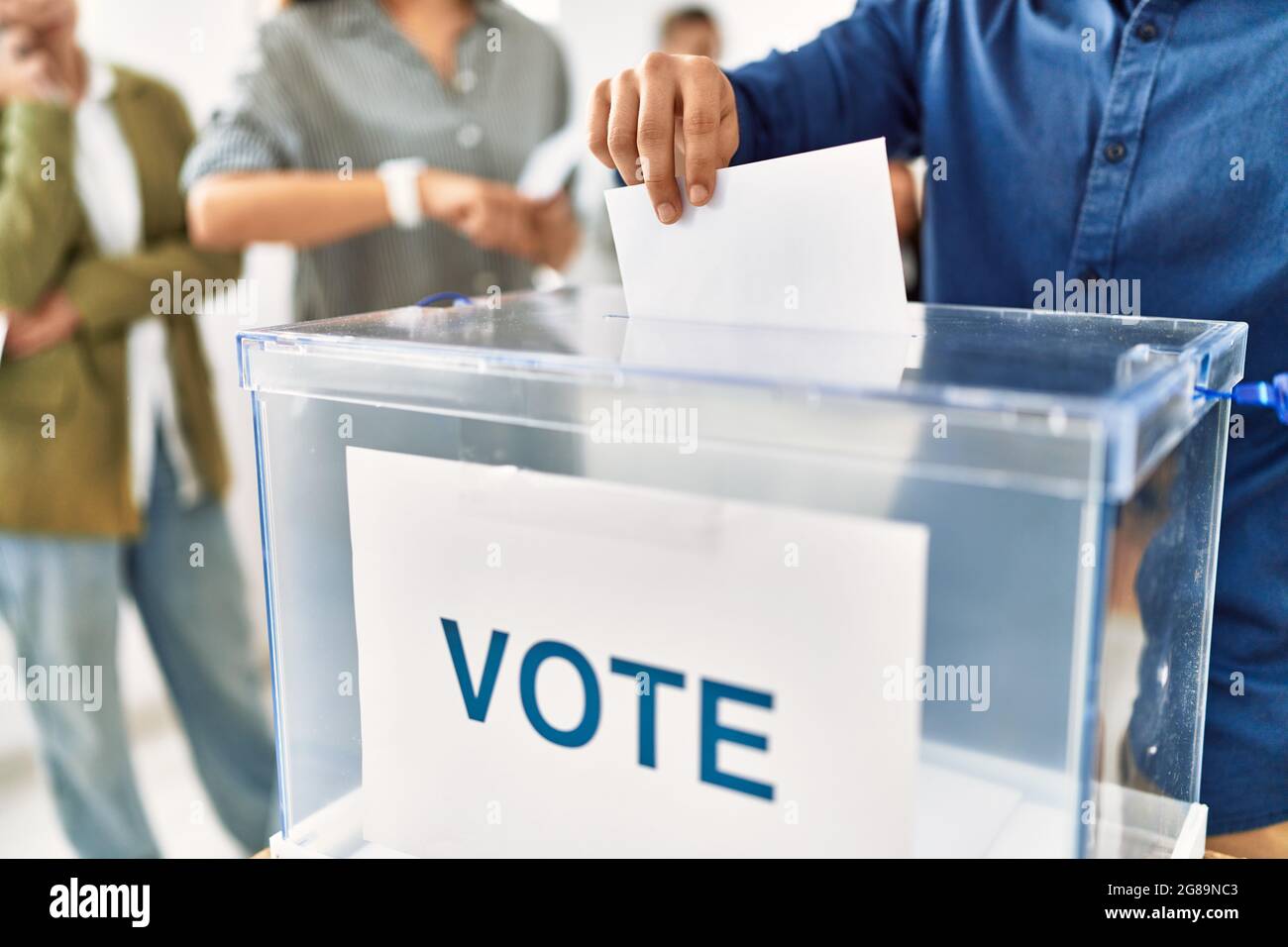 Hand of voter man putting vote in voting box at electoral center Stock ...