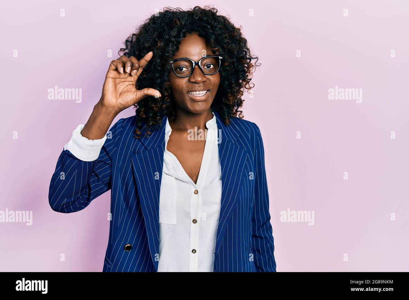 Young african american woman wearing business clothes and glasses ...
