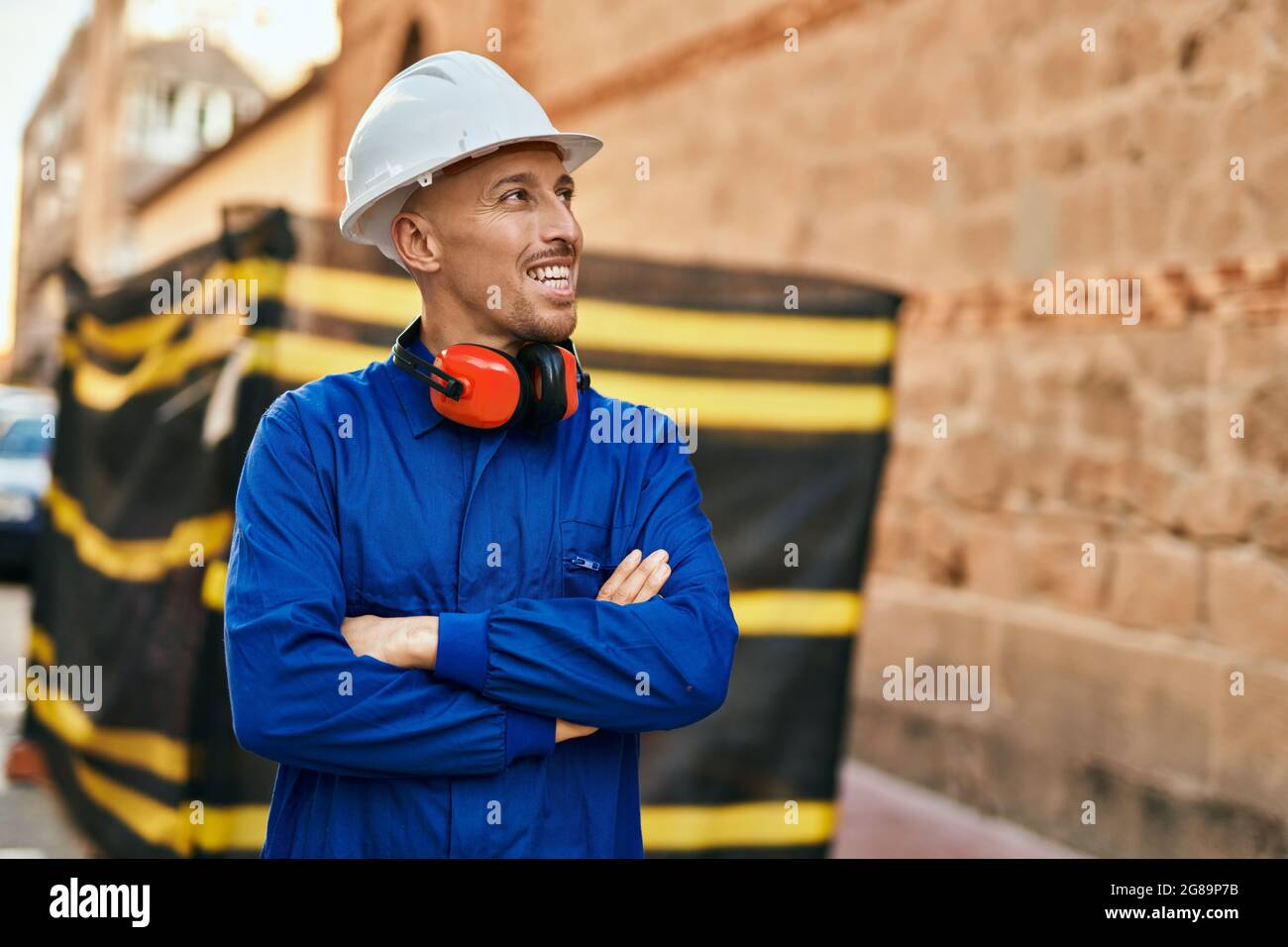Young caucasian worker smiling happy wearing uniform at the city Stock ...