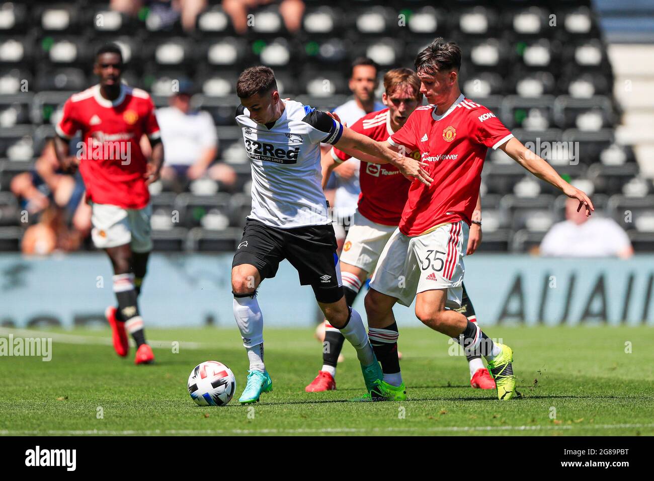 Tom Lawrence #10 of Derby County shields the ball from Dylan Levitt #35 ...