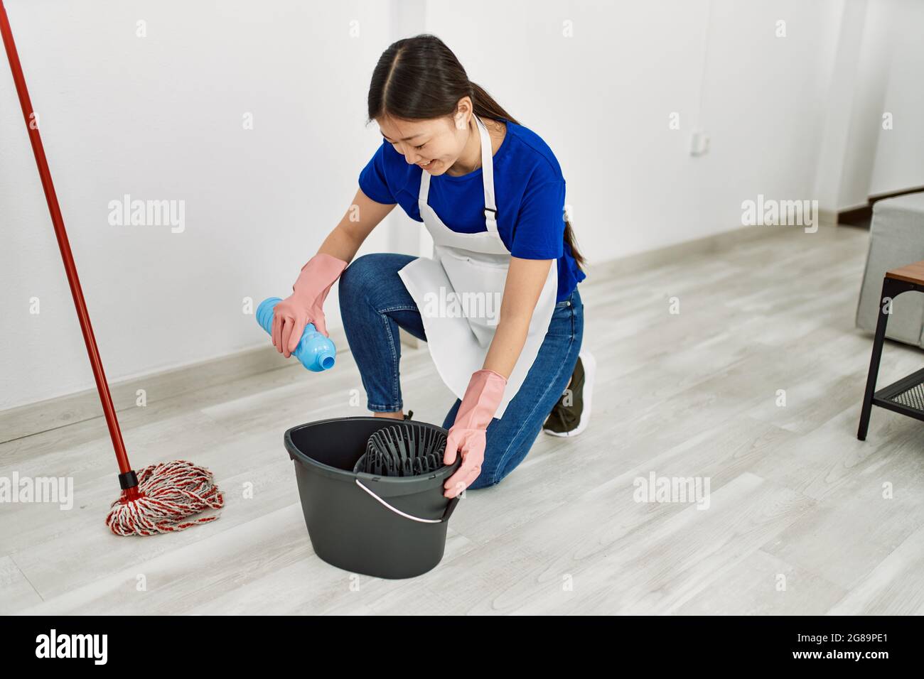 Young chinese housewife pouring cleaning product on washing cube at ...