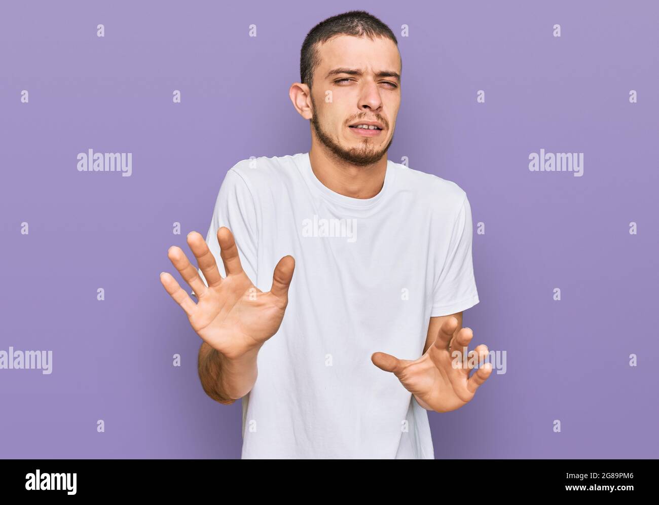 Hispanic young man wearing casual white t shirt disgusted expression ...