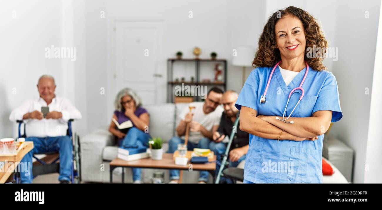 Middle age doctor woman smiling happy standing with arms crossed ...