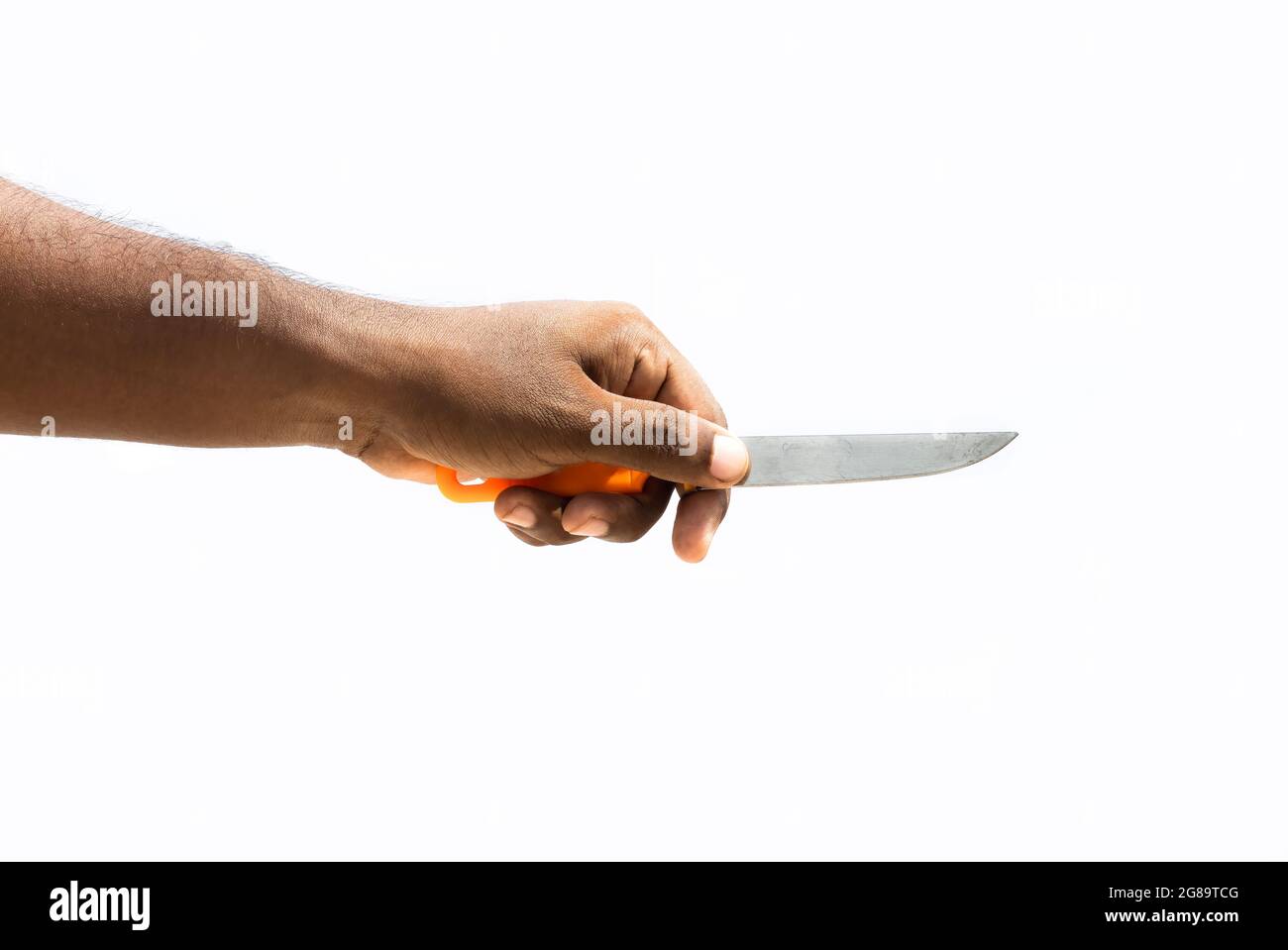 A used kitchen knife on a male hand close up isolated on white ...