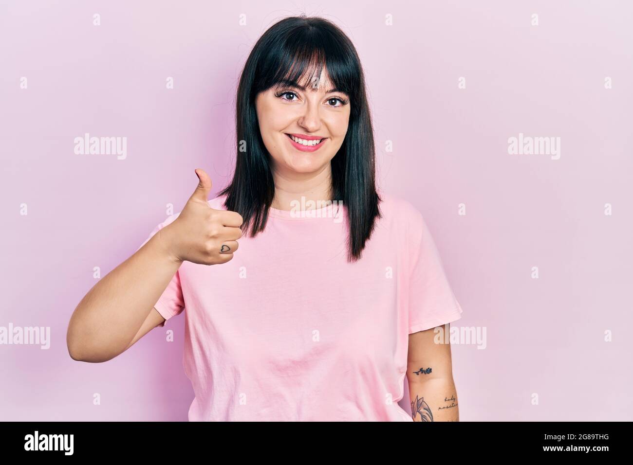Young hispanic woman wearing casual clothes doing happy thumbs up ...