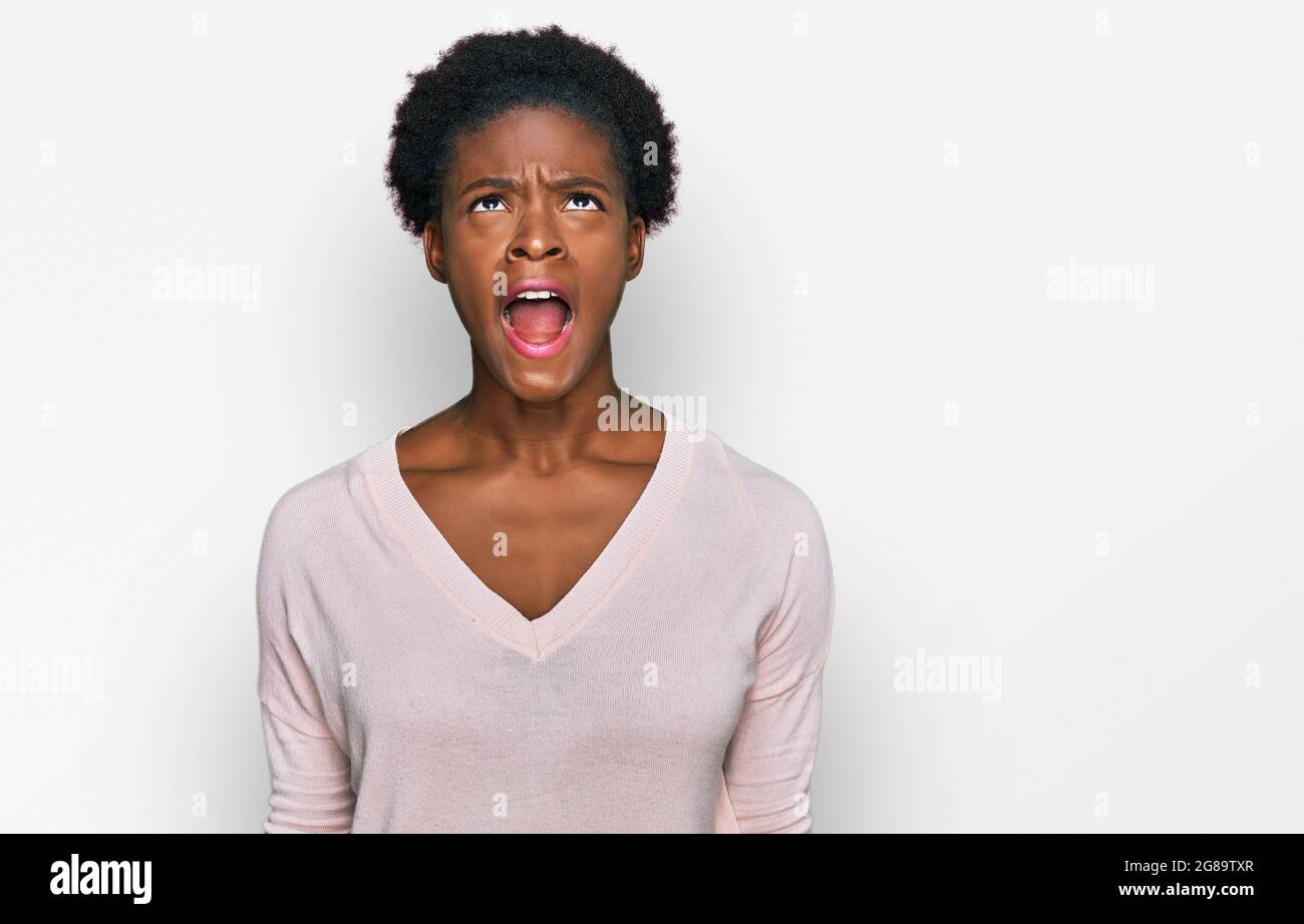 Young african american girl wearing casual clothes angry and mad ...