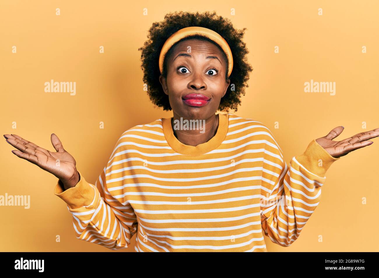 Young african american woman wearing casual sweatshirt clueless and ...