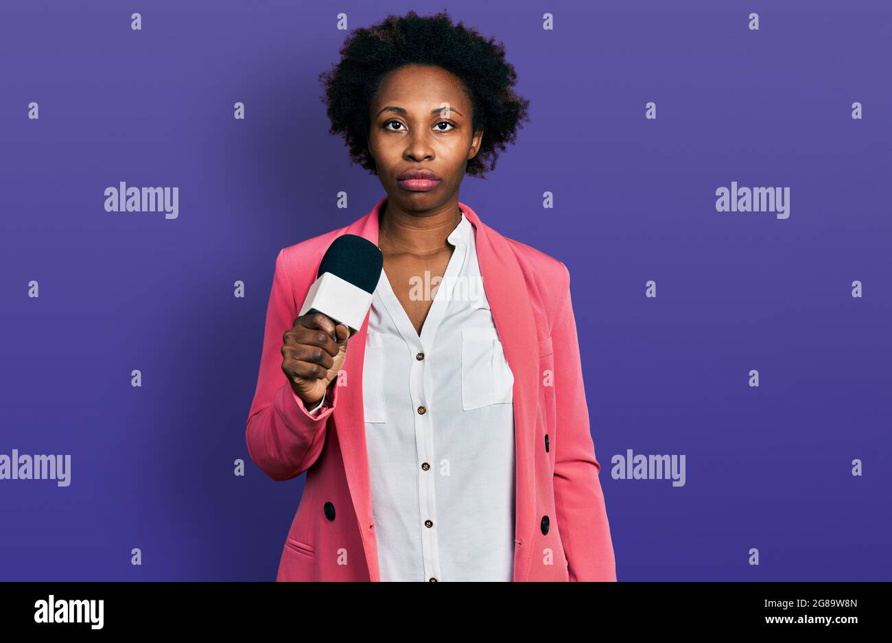 African american woman with afro hair holding reporter microphone ...