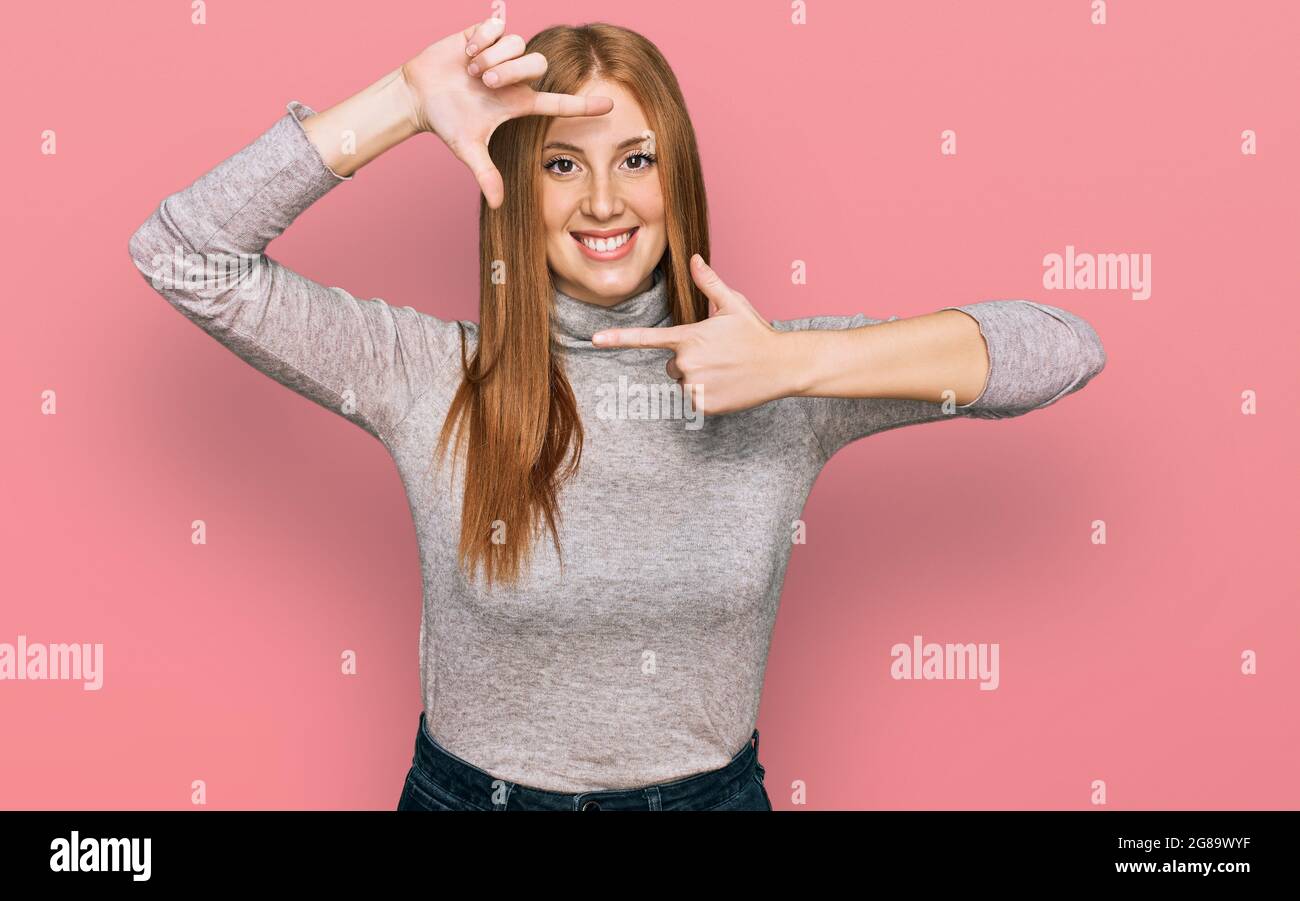 Young irish woman wearing casual clothes smiling making frame with ...