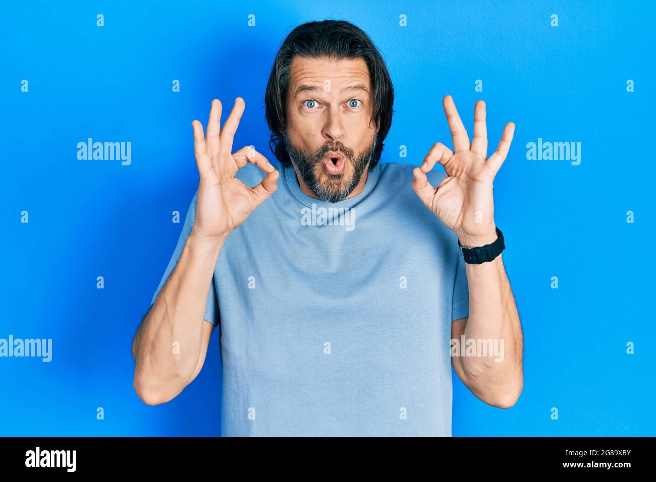 Middle age caucasian man wearing casual clothes looking surprised and ...
