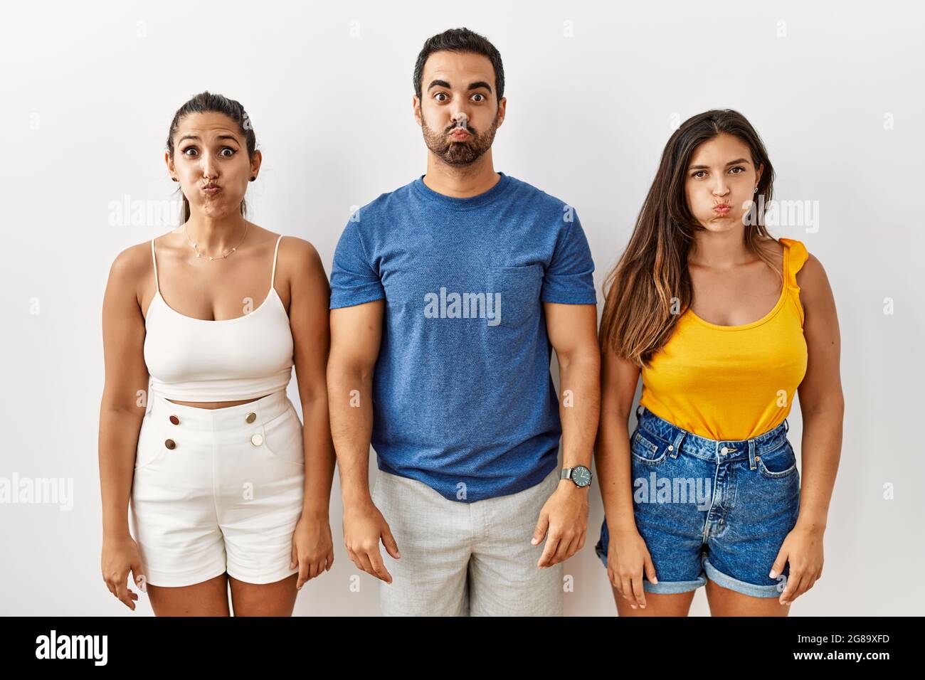 Group of young hispanic people standing over isolated background ...