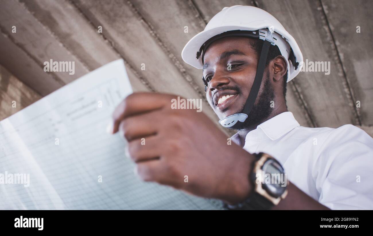 African architects engineer looking with a blueprint work together in ...