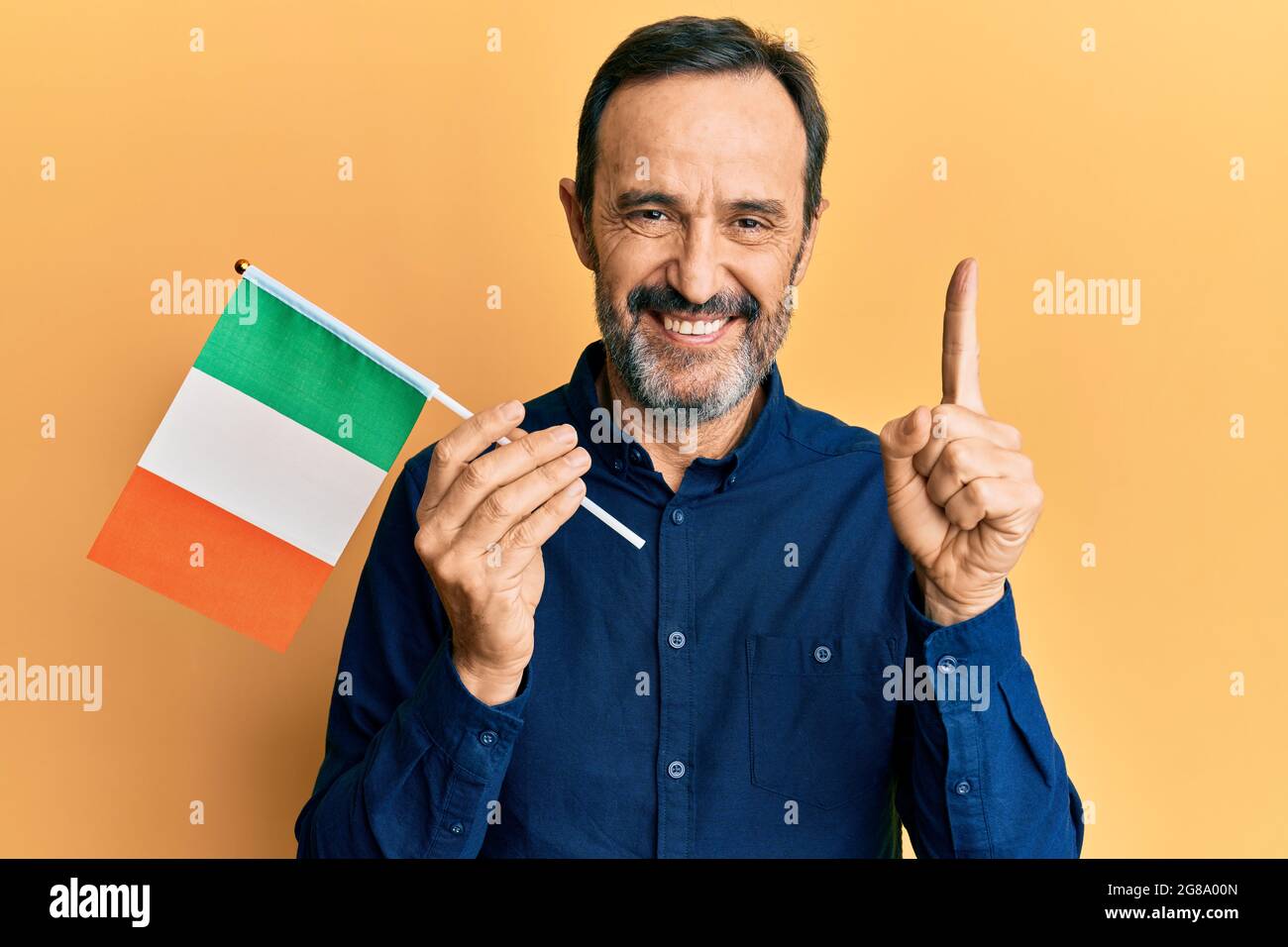 Middle age hispanic man holding ireland flag smiling with an idea or ...
