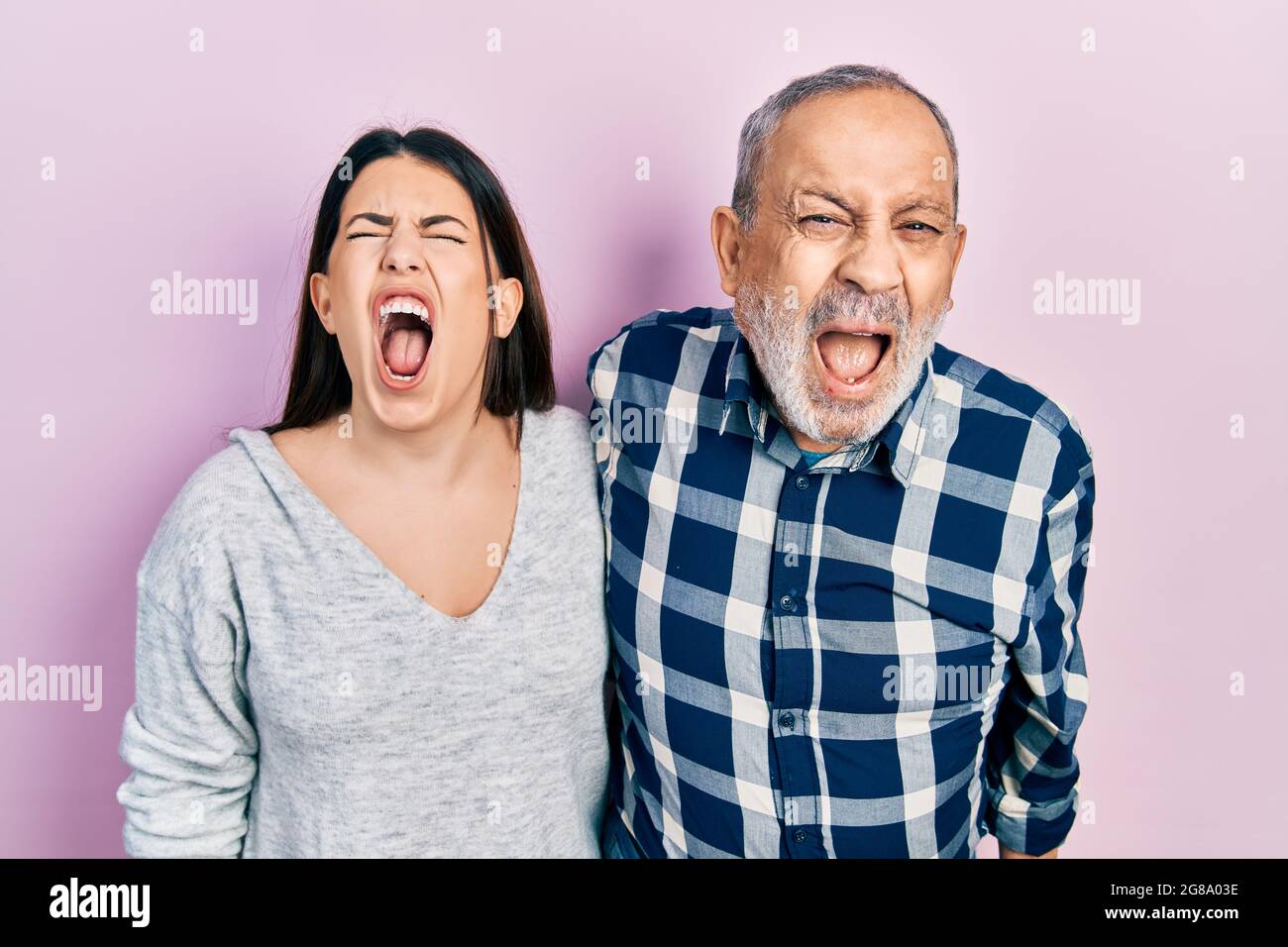 Hispanic father and daughter wearing casual clothes angry and mad ...