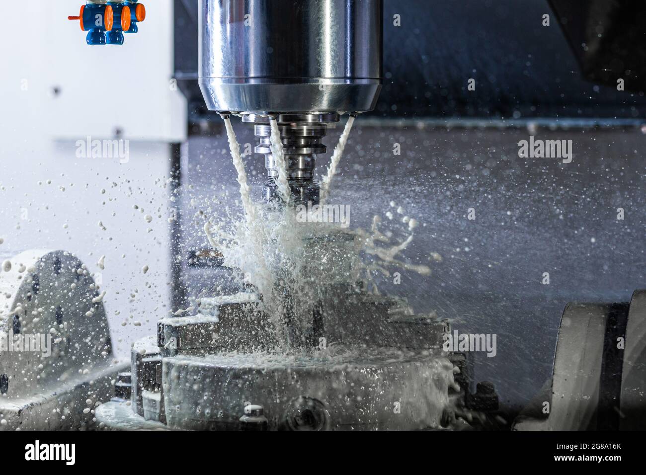 a process of industrial wet milling in 5-axis cnc machine with coolant ...