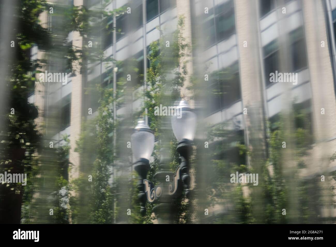 Old style street lights in front of newer architecture in Portland ...