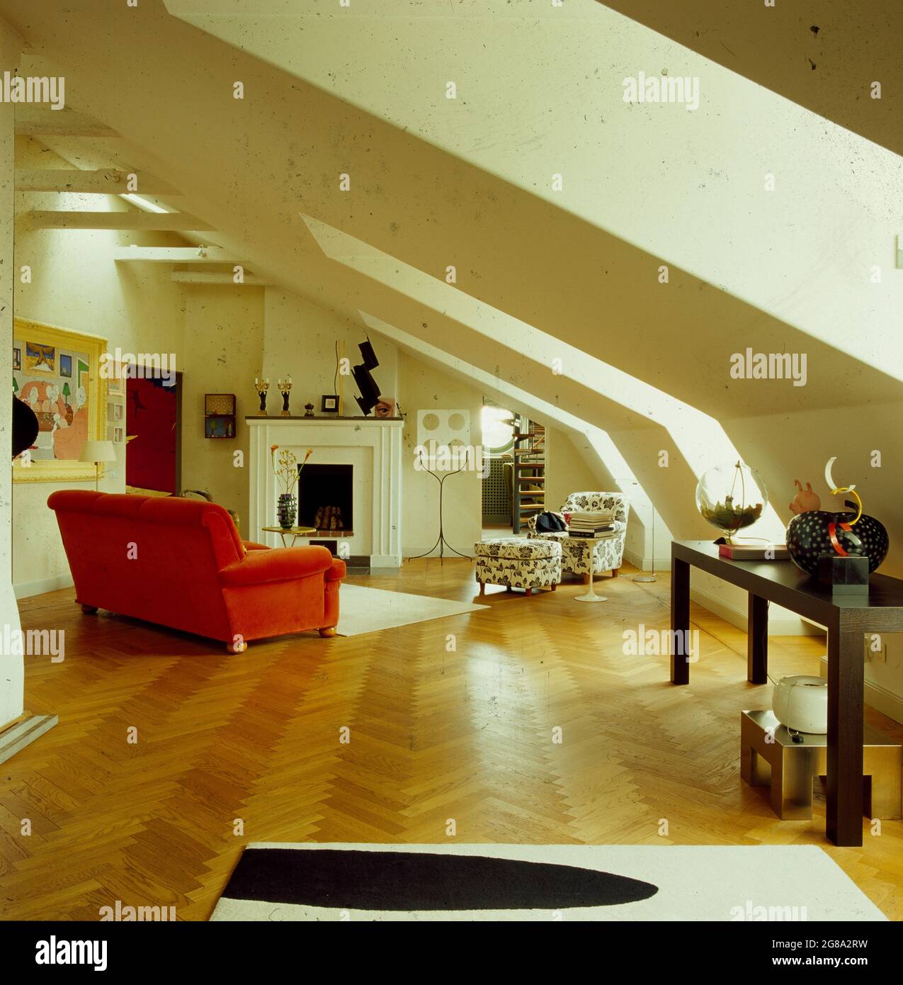 Attic livingroom with sloping ceiling a d herringbone parquet flooring ...