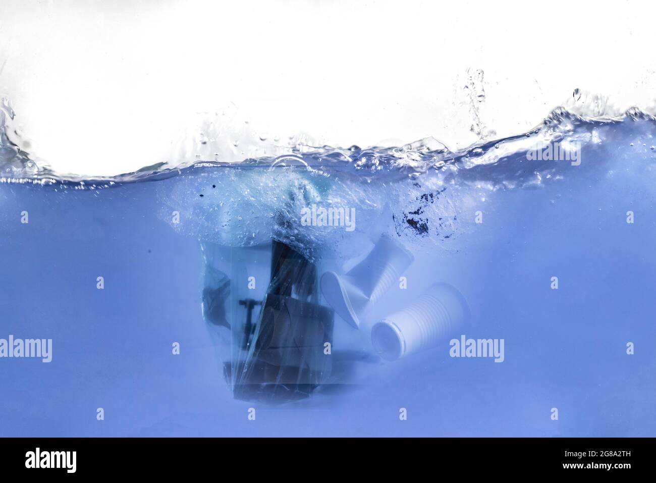 plastic package with waste garbage inside float in the ocean water ...