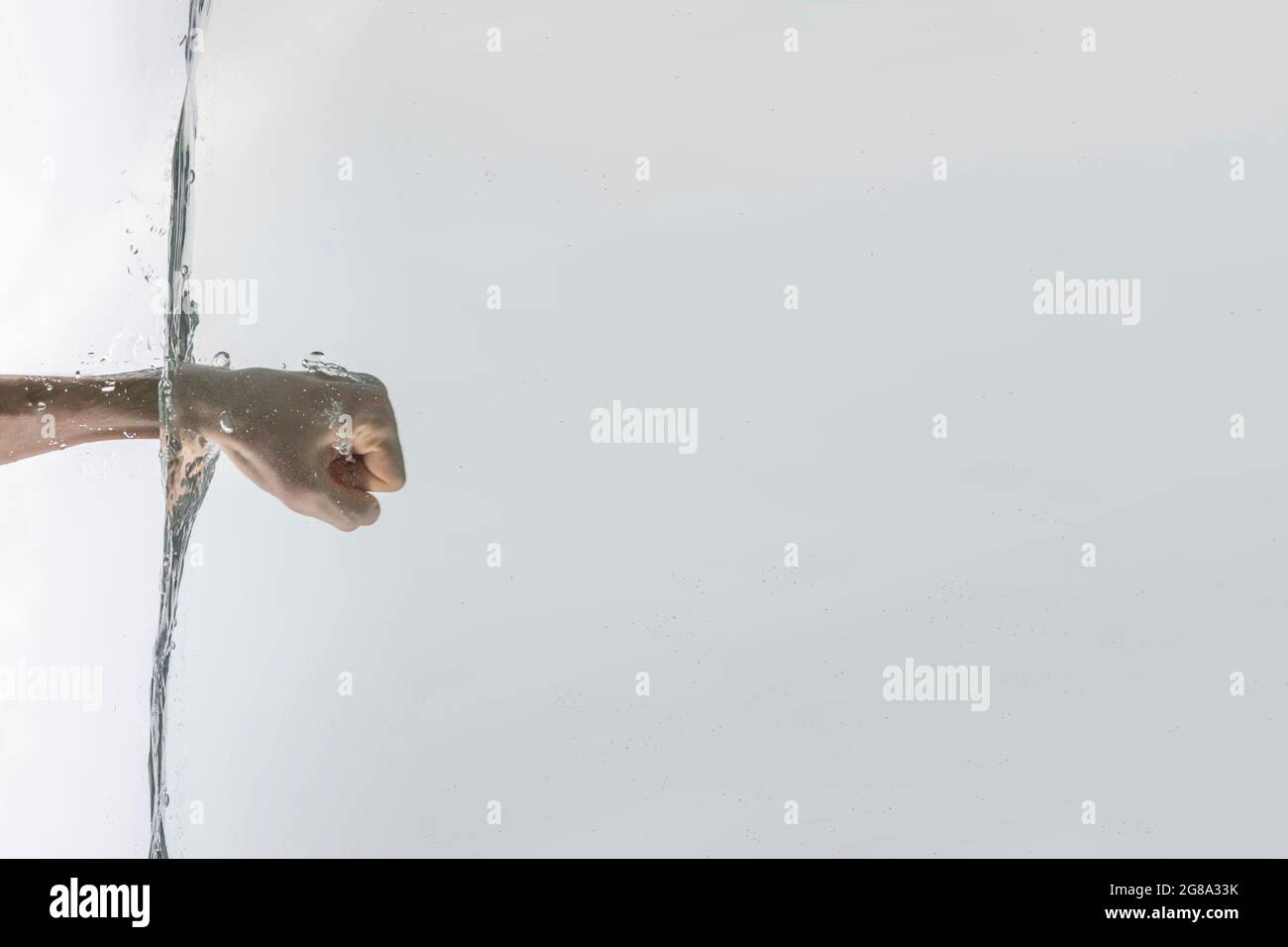 Hand through water wall hi-res stock photography and images - Alamy