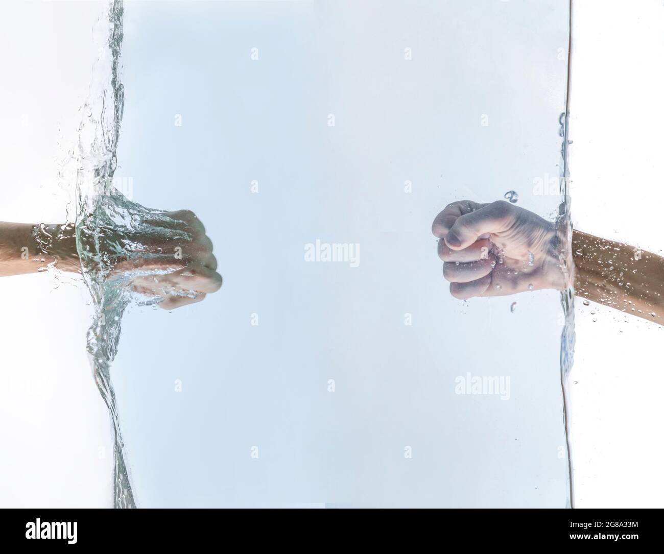 two fists of friends punch each other underwater, beat through water ...