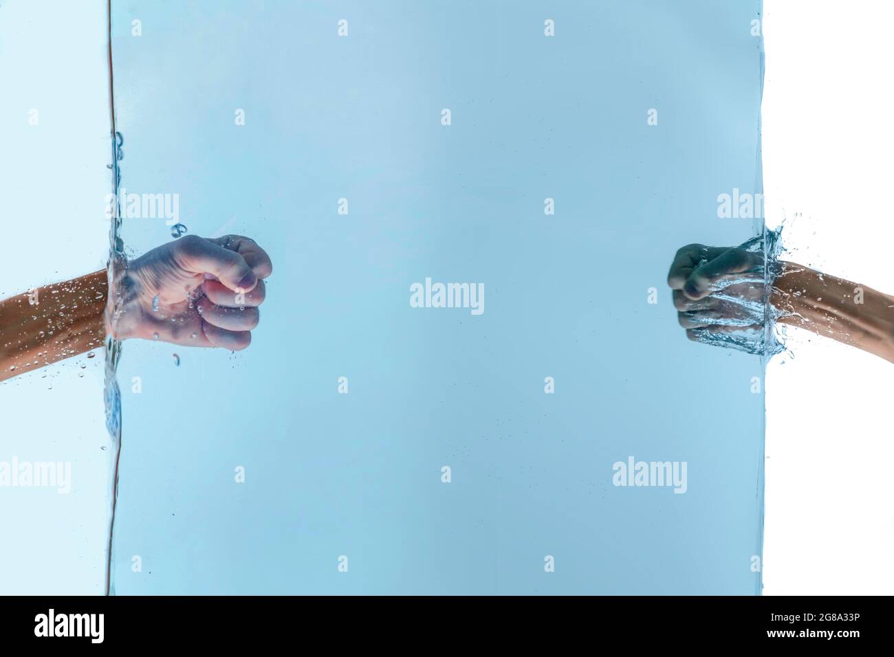 two fists of friends punch each other underwater, beat through water ...
