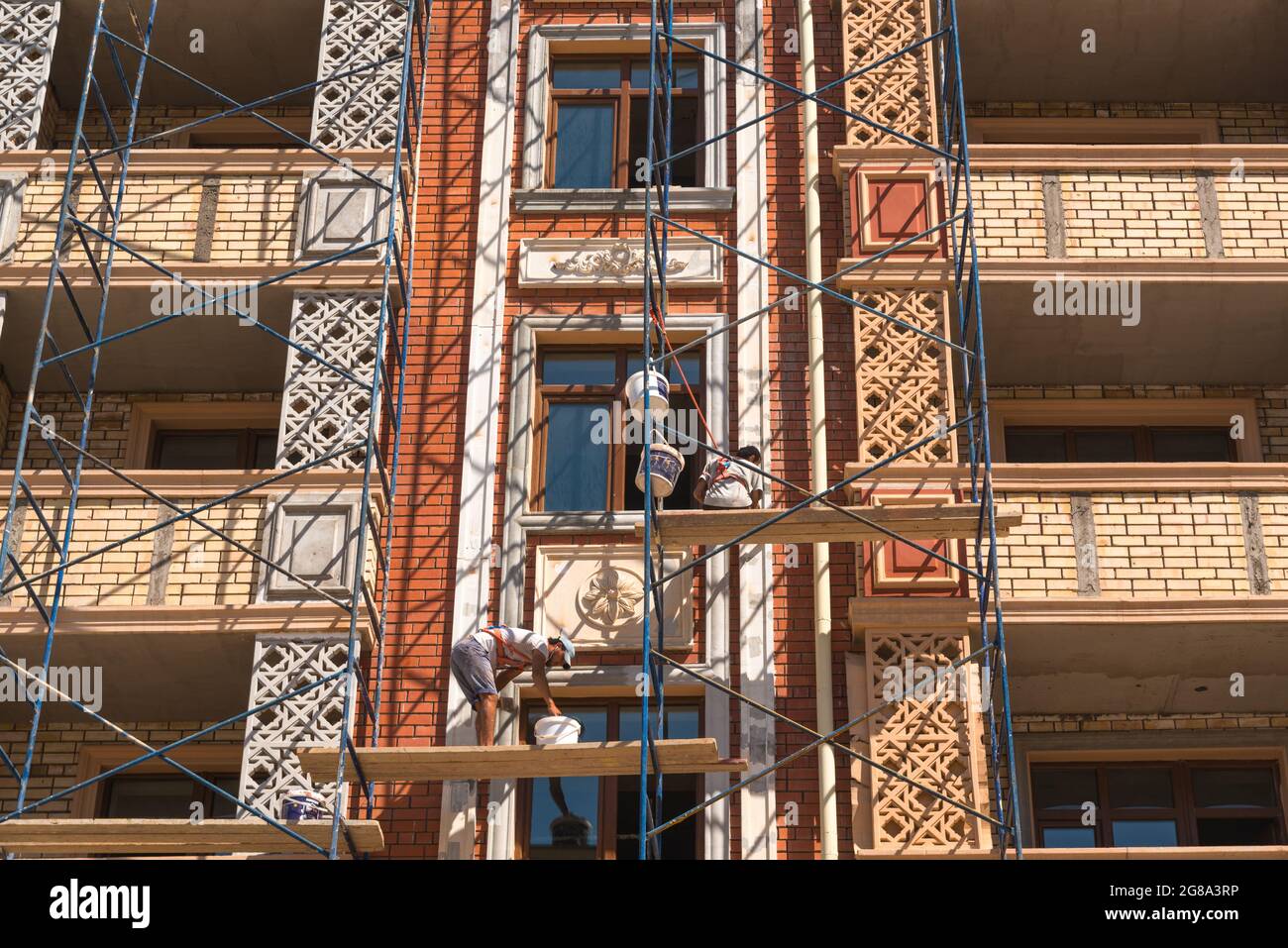 Finishing works on the facade of a new residential buildings Stock ...