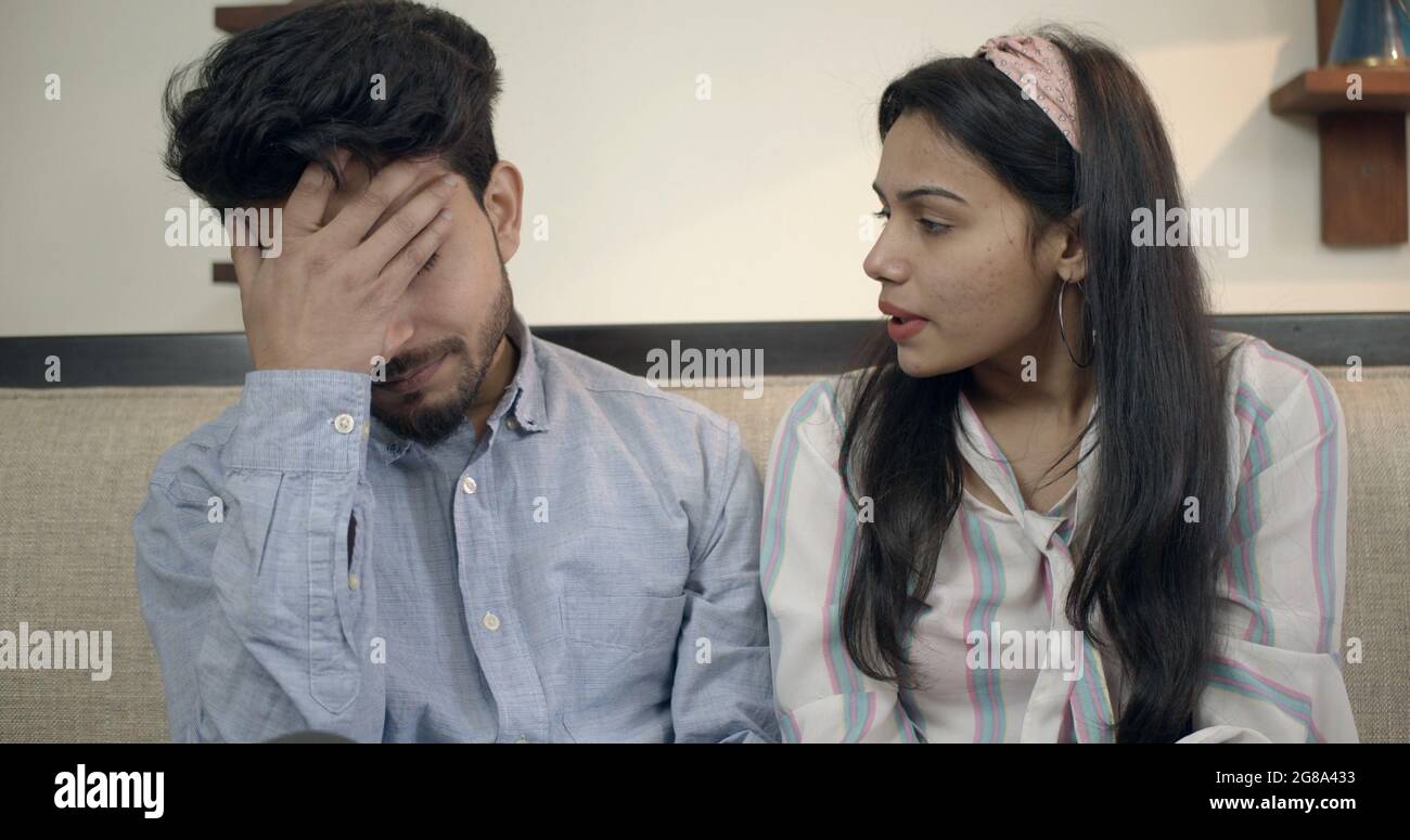 A young Indian couple having a serious conversation about their ...