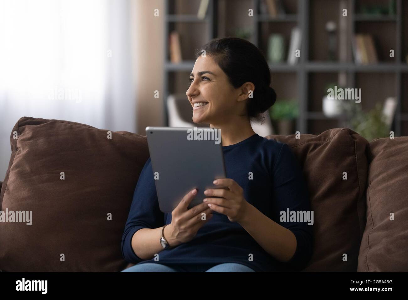 Happy Indian woman use tablet browsing internet at home Stock Photo - Alamy