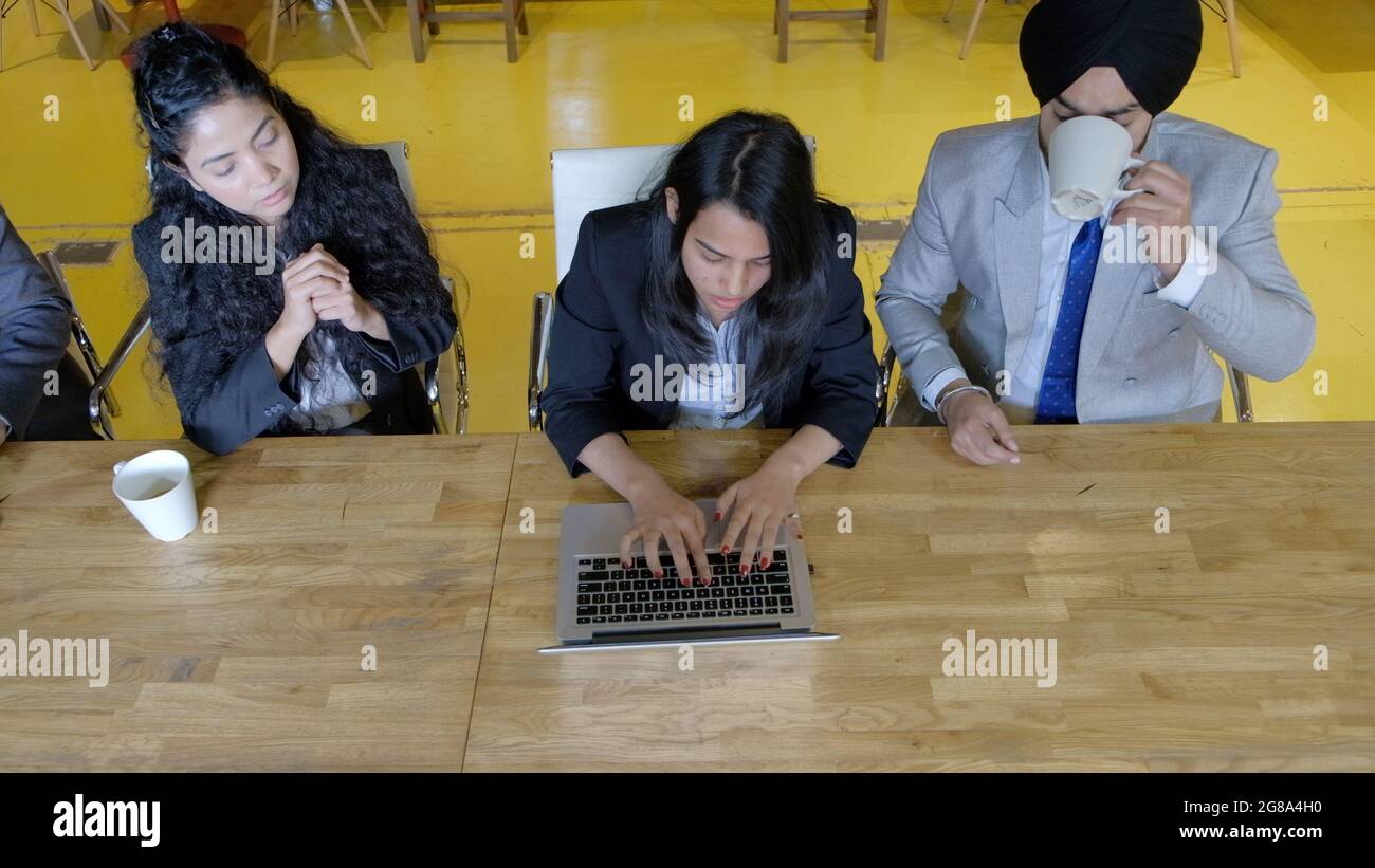 A closeup shot of a group of Indian people working in the office Stock ...