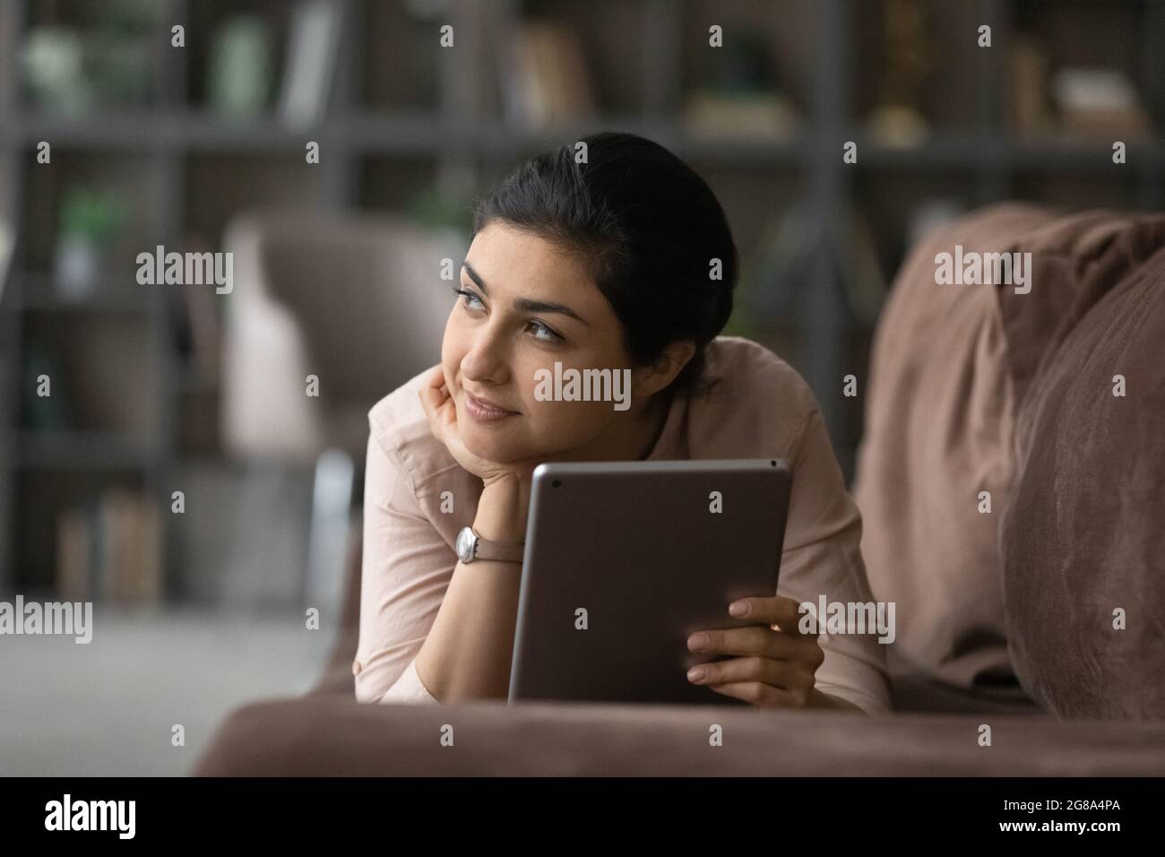 Indian woman use tablet make plans dreaming Stock Photo - Alamy