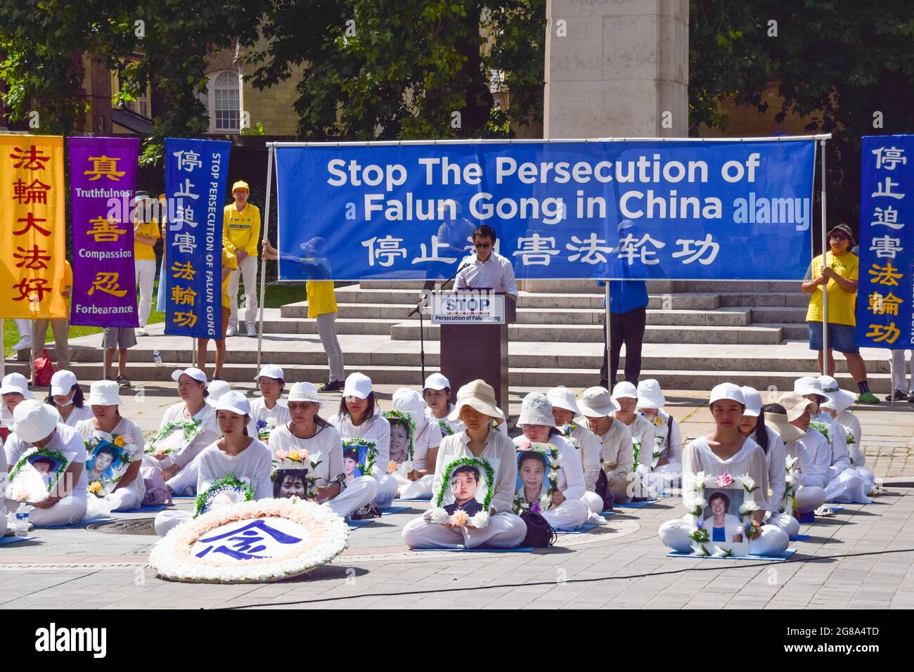 Falun Gong demonstrators hold pictures of victims of persecution during ...