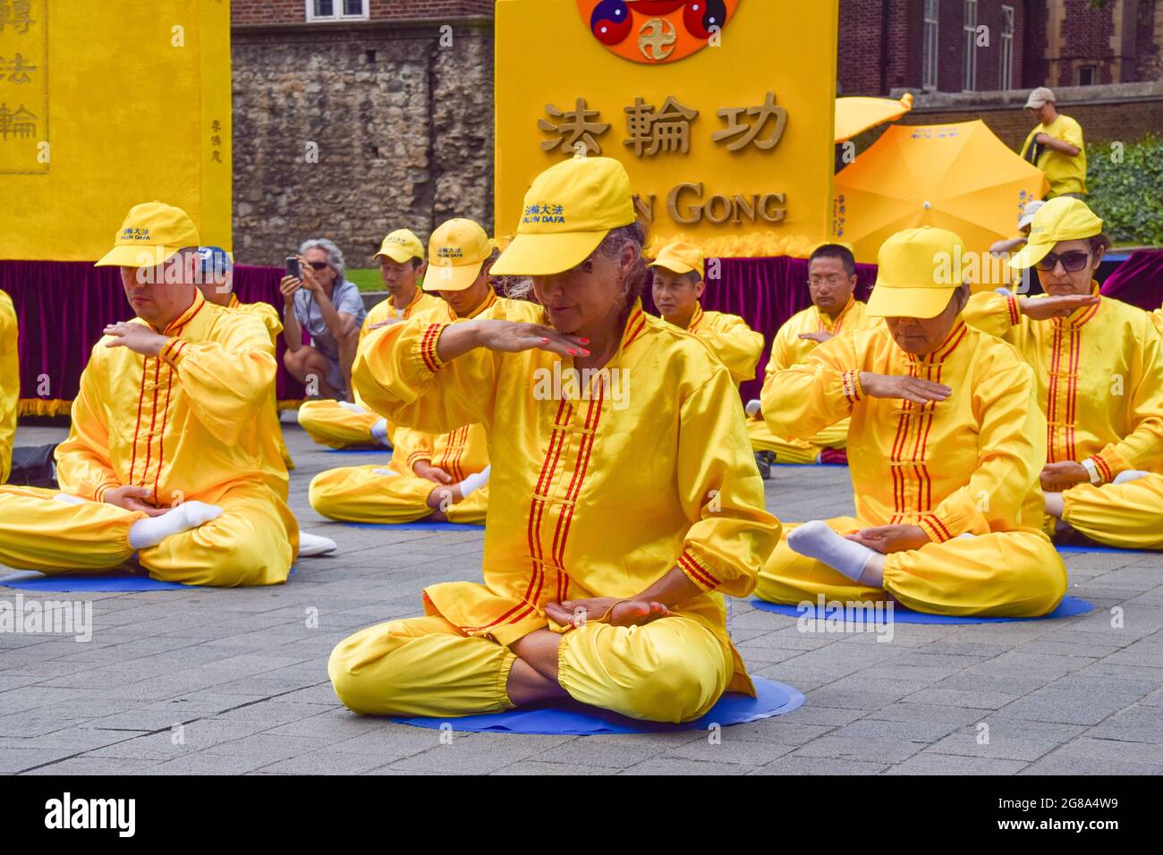Falun Gong practitioners meditating during the protest.Practitioners ...